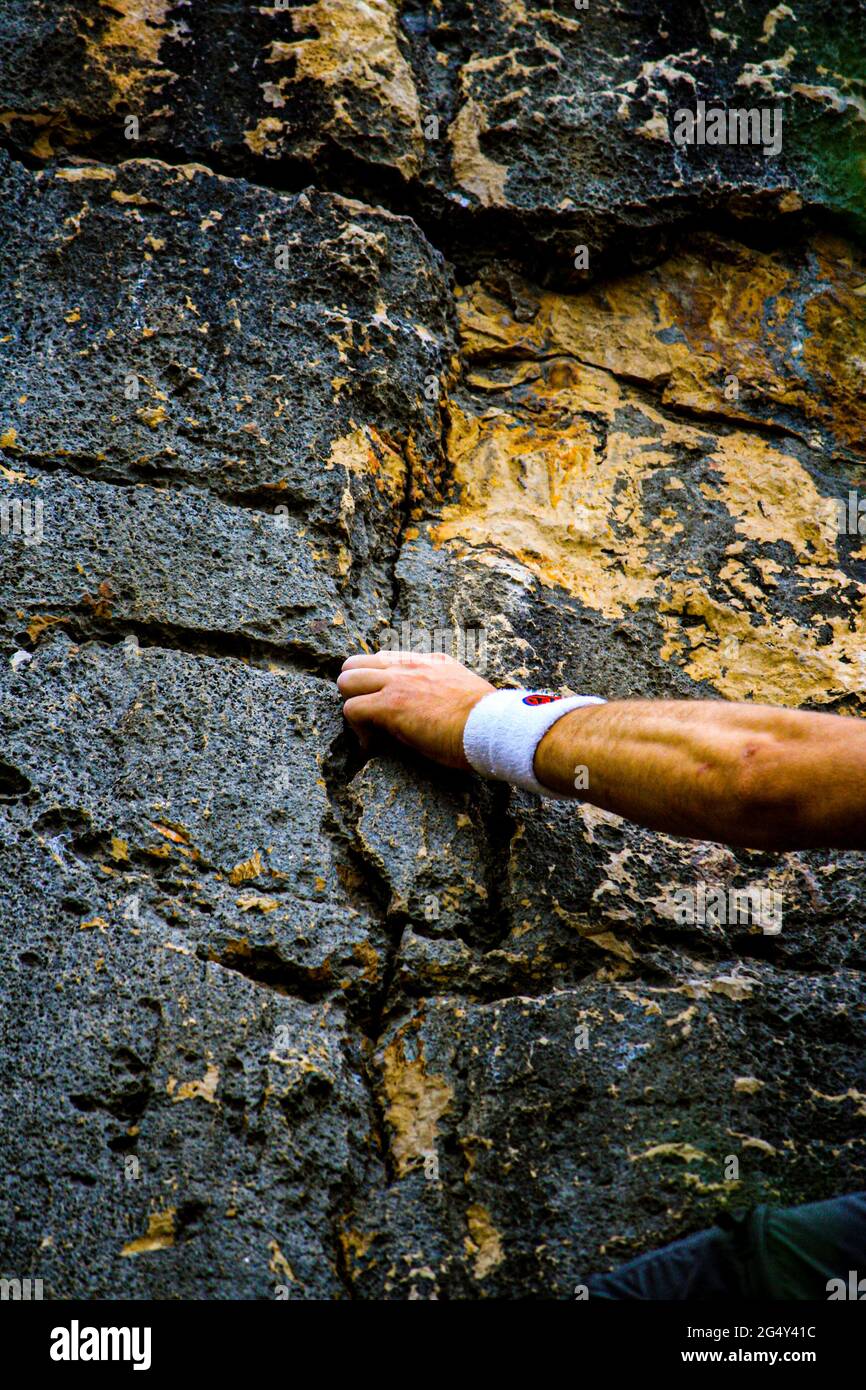 climbing. hand of climber grabs the rock. vertical format Stock Photo ...