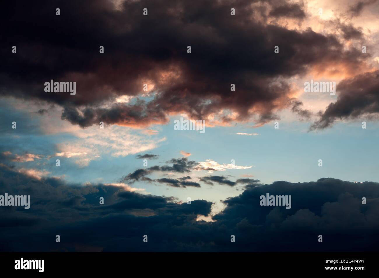 Colorful sunset and dark cloudy sky . Dramatic sunset in worm tone ...