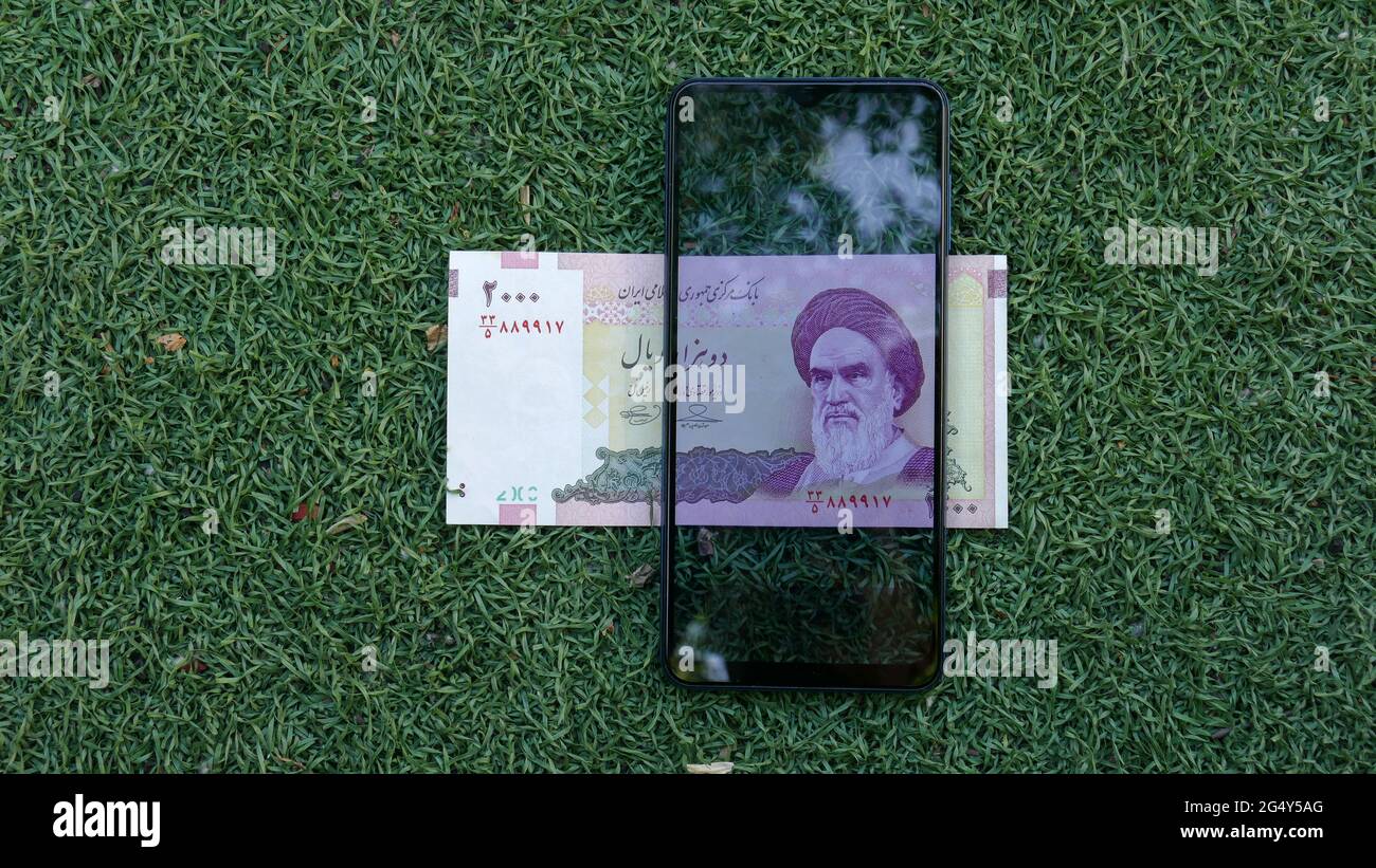 Rolled Saudi Arabian Riyal banknotes view via smartphone Stock Photo ...