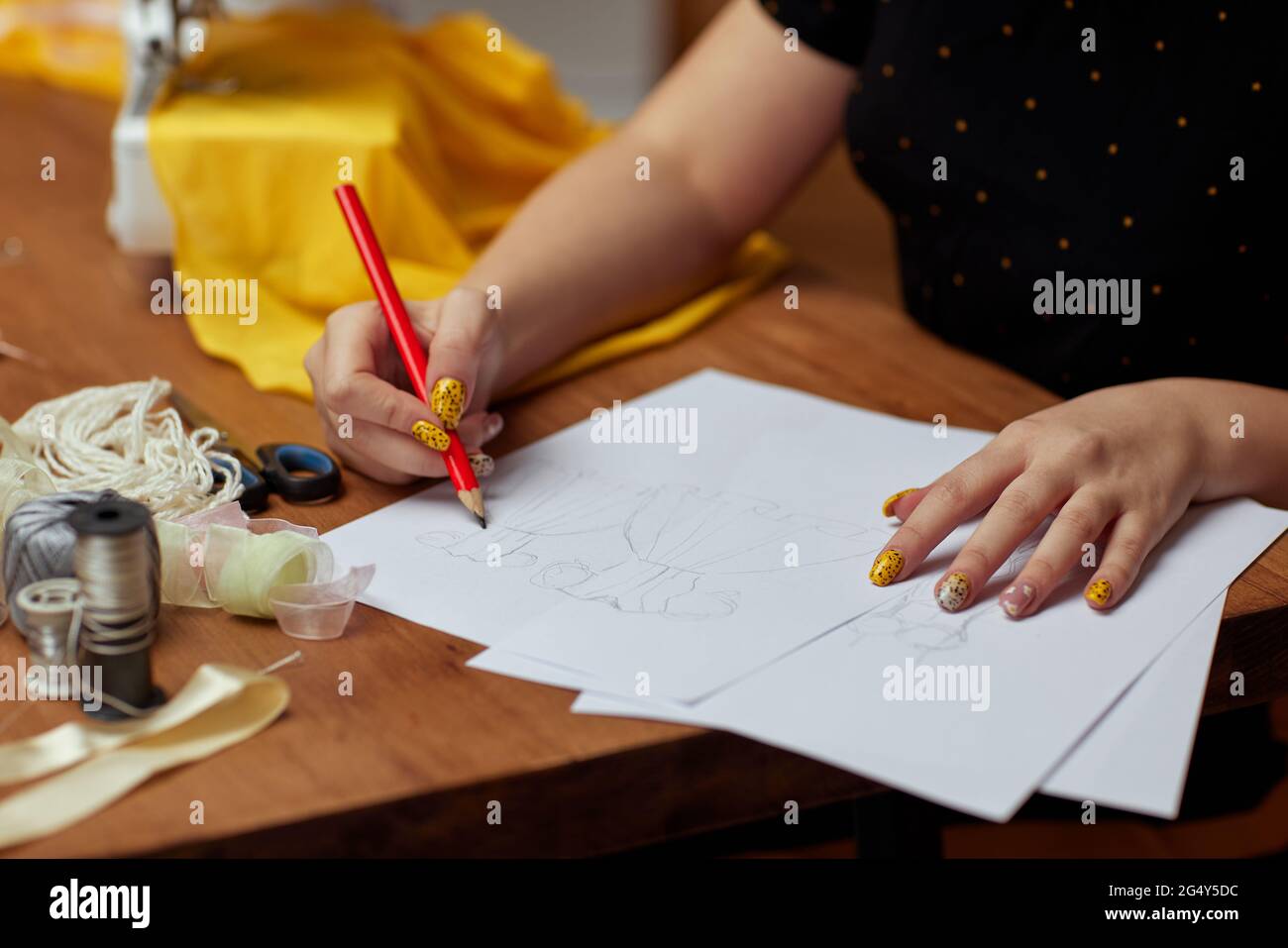 Fashion designer drawings with a pencil sketches Stock Photo - Alamy