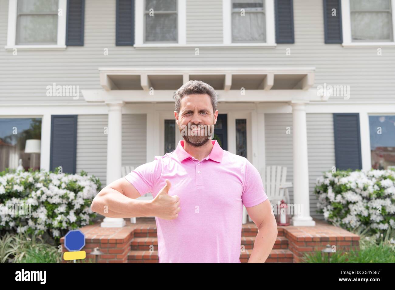 happy owner show thumb up. ownership. confident man outside new ...