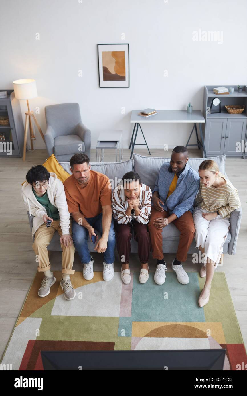 Multi ethnic group people watching tv hi-res stock photography and ...