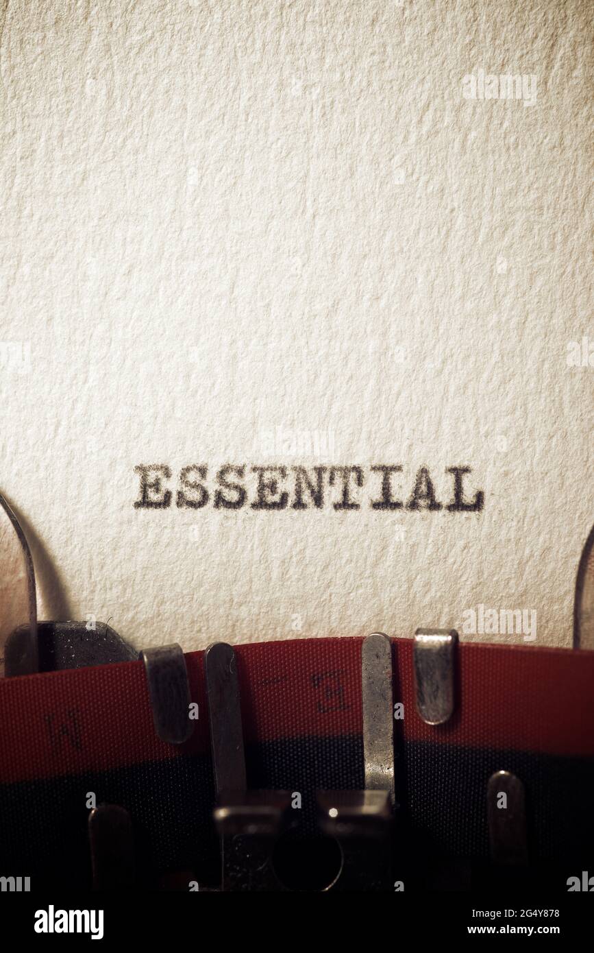 The word essential written with a typewriter Stock Photo - Alamy