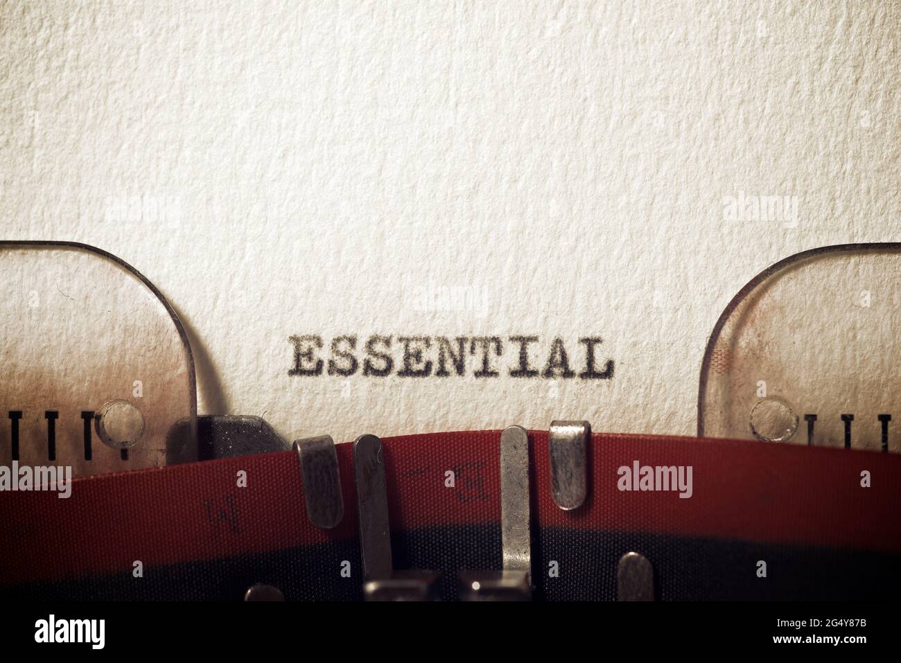 The word essential written with a typewriter Stock Photo - Alamy