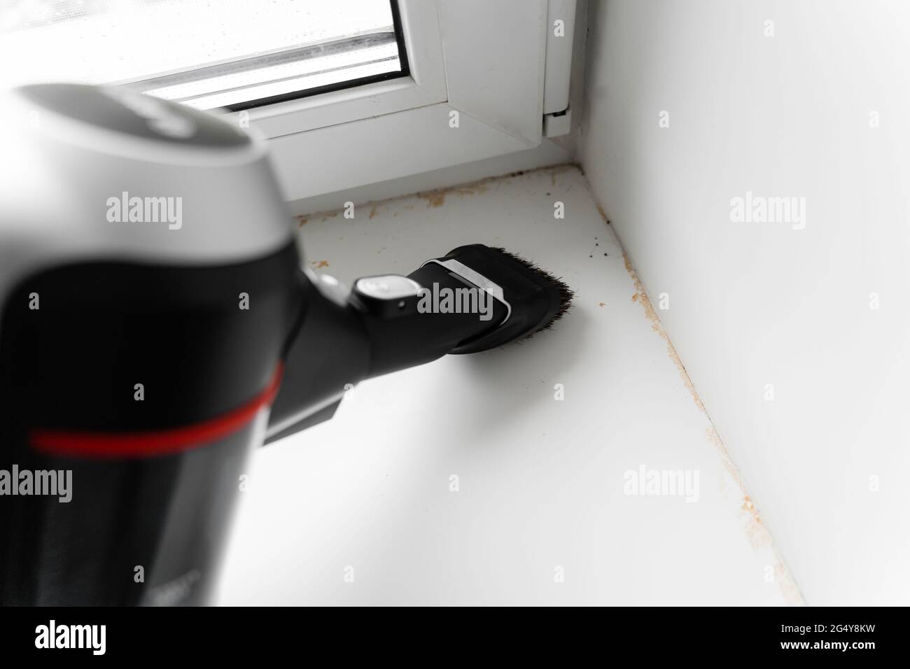 Cleaning furniture and window countertops with wireless vacuum cleaner ...