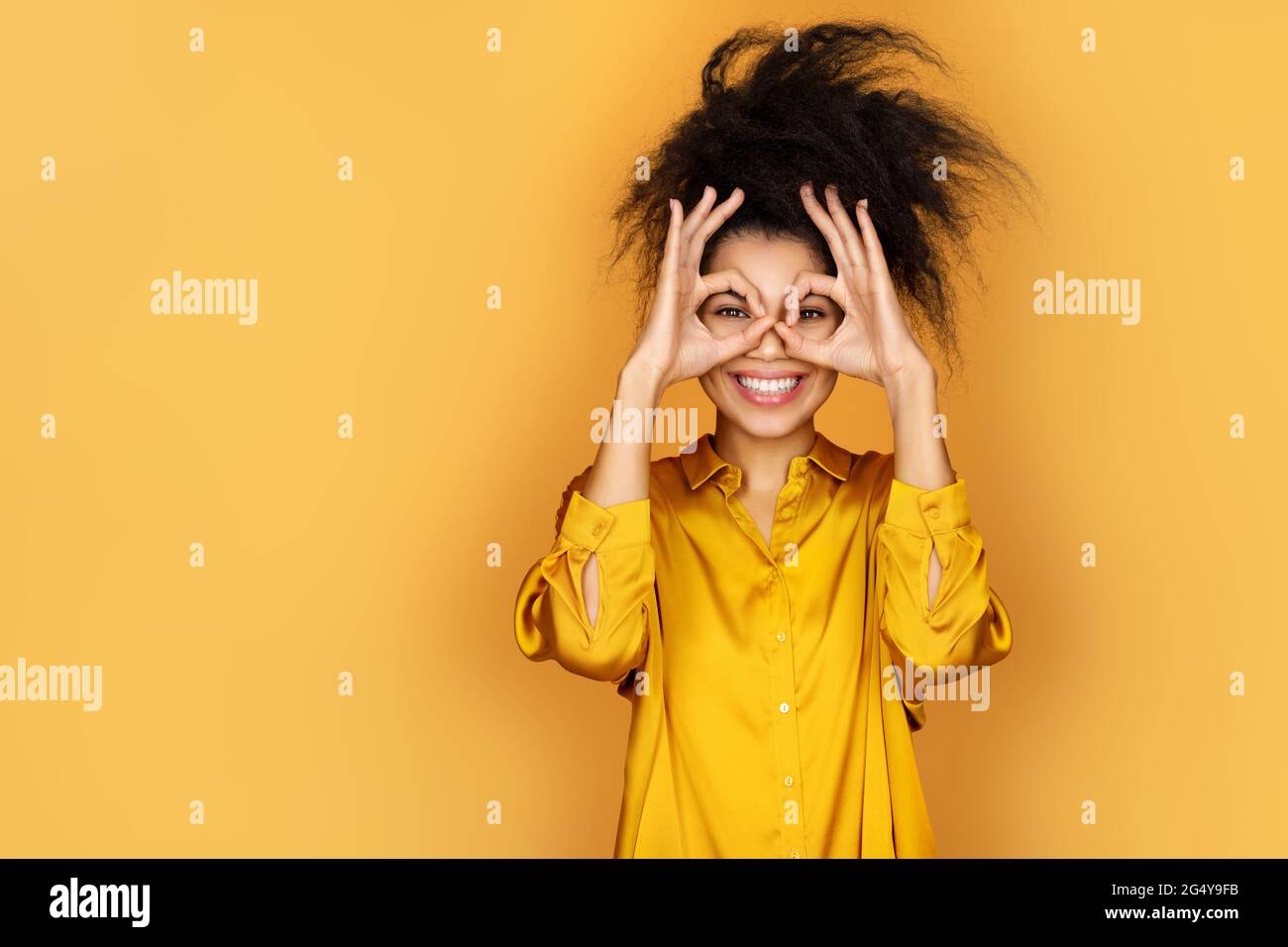 Smiling girl shows ok sign with both hands, says good job or well done ...