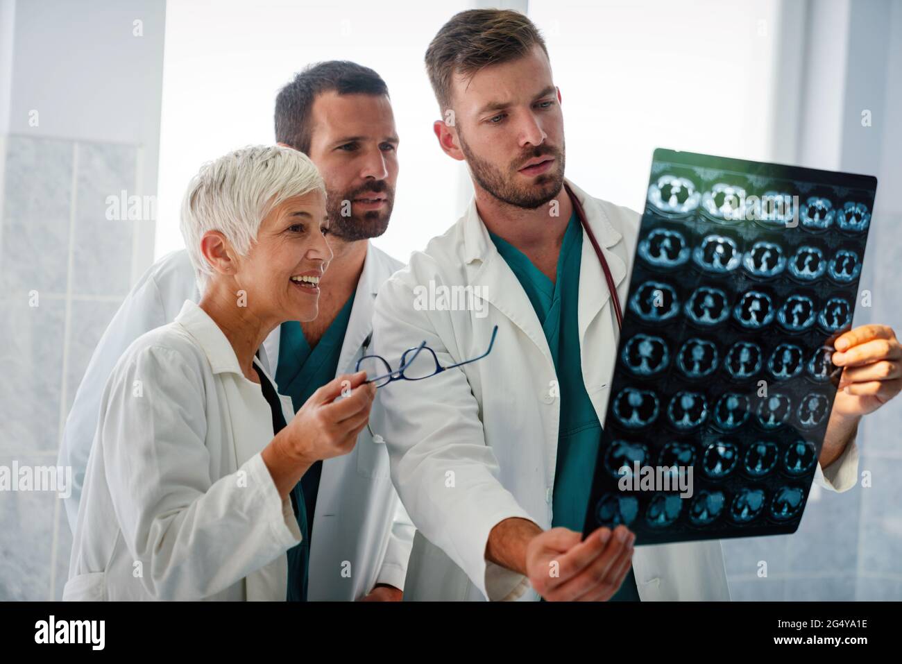 Radiologist doctor consulting with colleagues an x-ray scan in hospital ...
