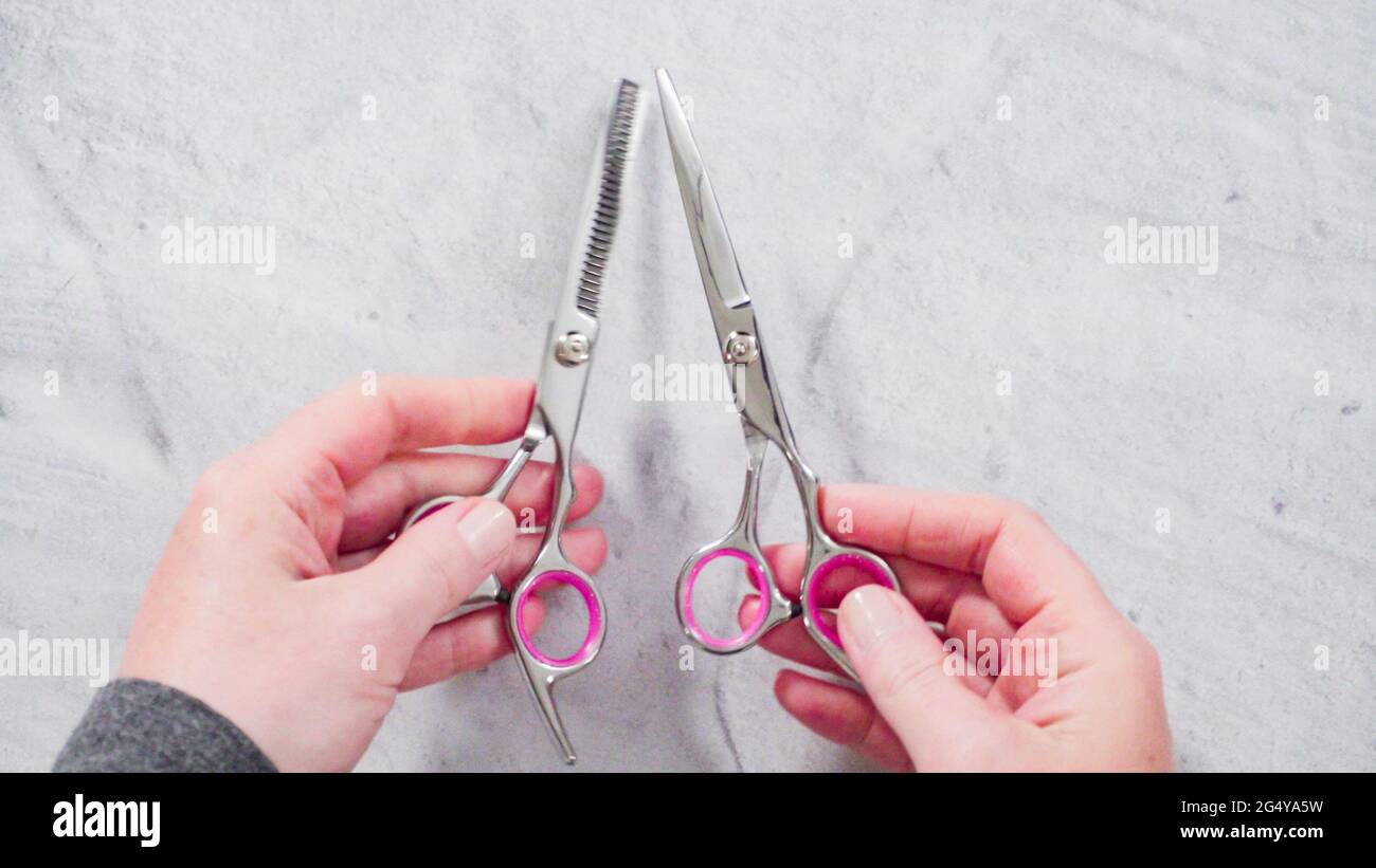 Flat lay. Pink hair cutting scissors set Stock Photo - Alamy