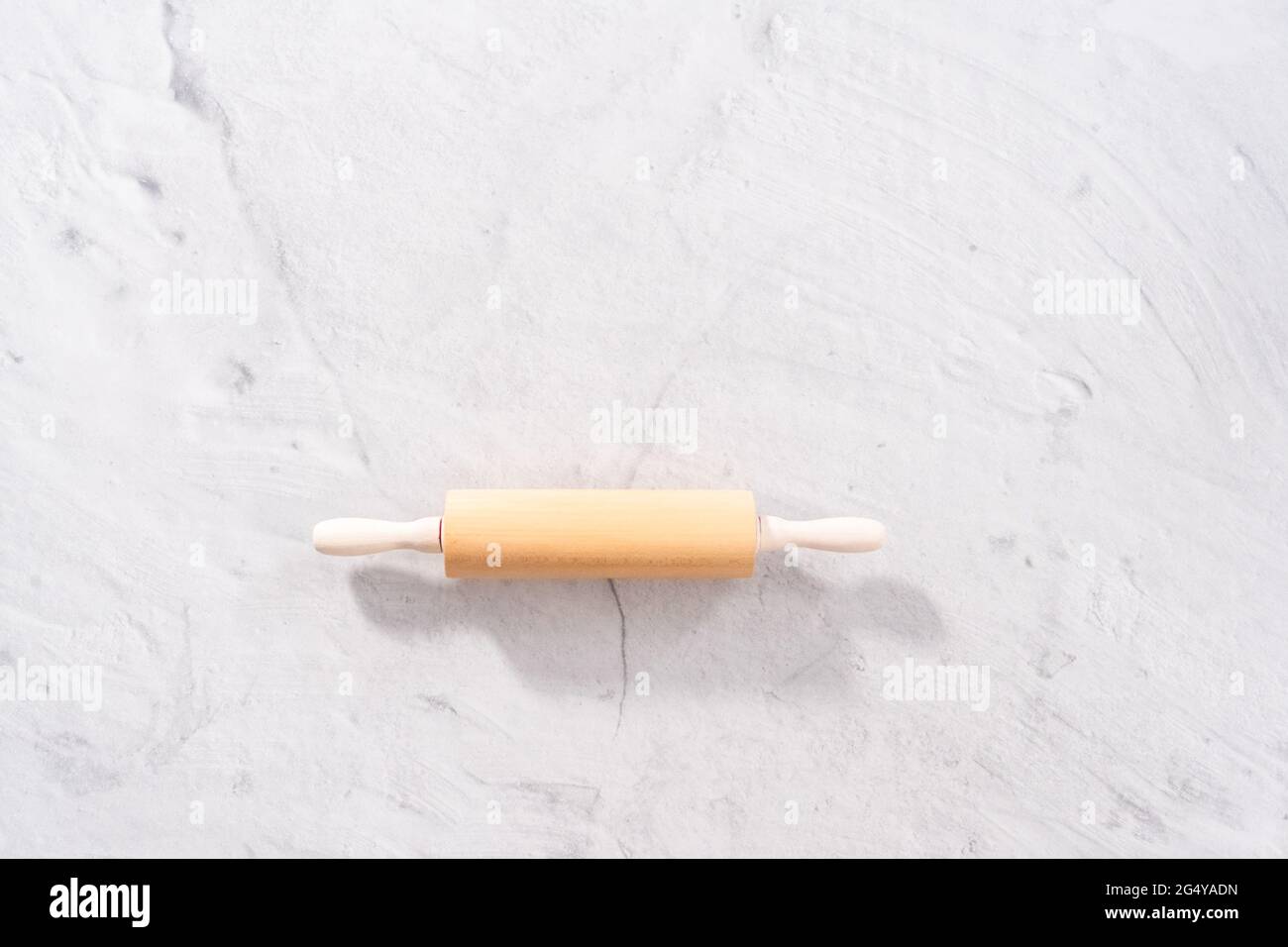 Flat lay. Wooden rolling pin on a kitchen counter Stock Photo - Alamy
