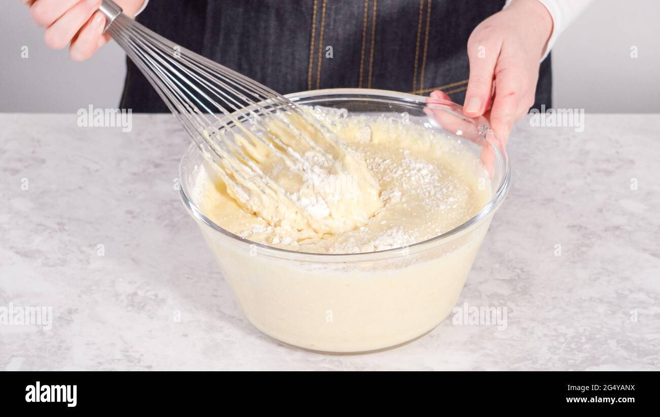 Step by step. Mixing ingredients in a glass mixing bowl to prepare ...