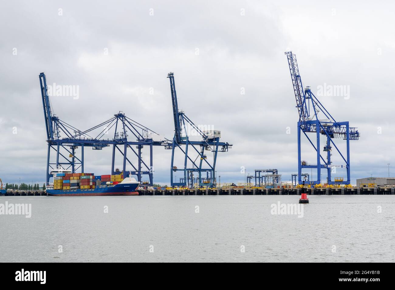 London Thamesport large cranes on Isle of Grain, Thames estuary, Kent ...