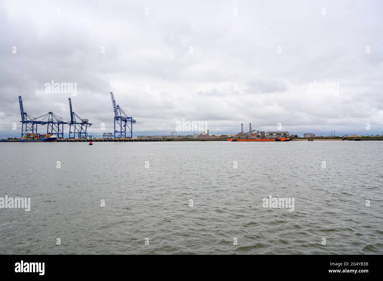 London Thamesport large cranes on Isle of Grain, Thames estuary, Kent ...