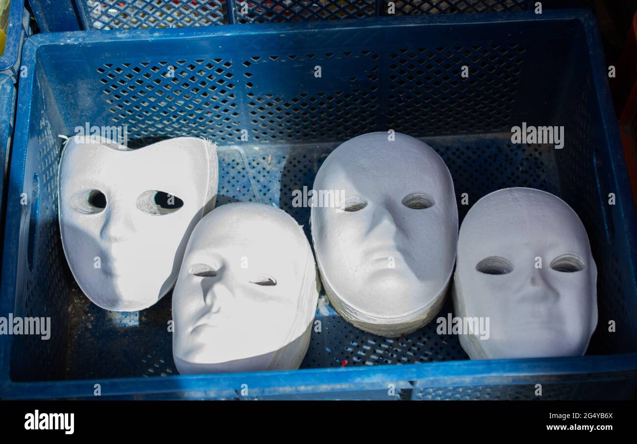 Box with white scary face masks Stock Photo - Alamy