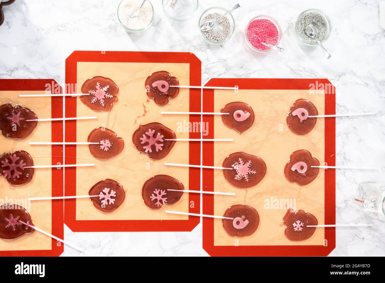 Flat lay. Making homemade berry flavor lollipops with snowflakes Stock ...