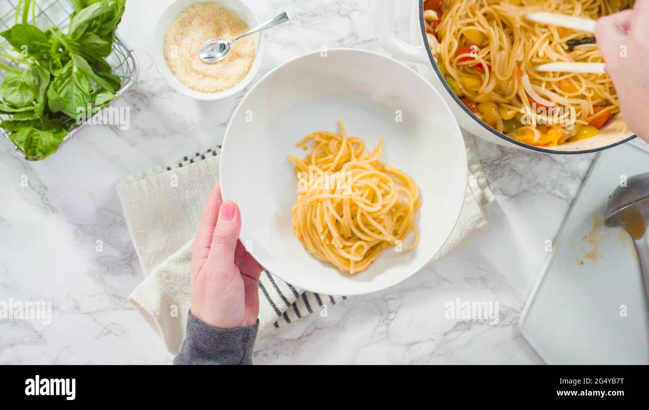 Flat lay. Step by step. Serving a one-pot pasta into a white pasta ...
