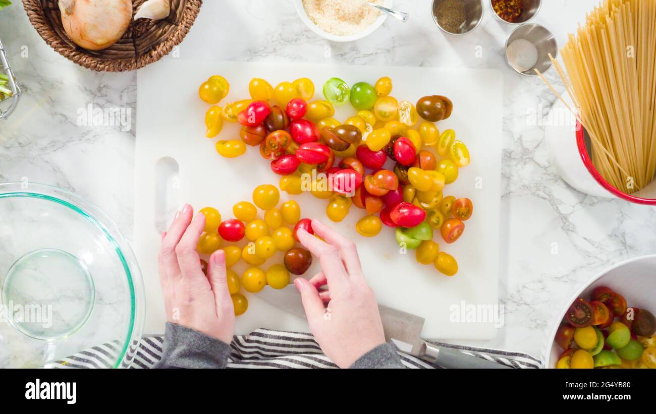 Flat lay. Step by step. Cutting vegetables on a white cutting board to ...
