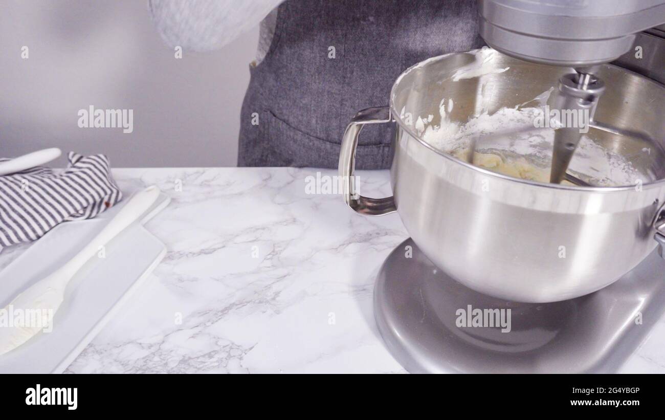 Step by step. Mixing ingredients in a standing kitchen mixer to prepare ...