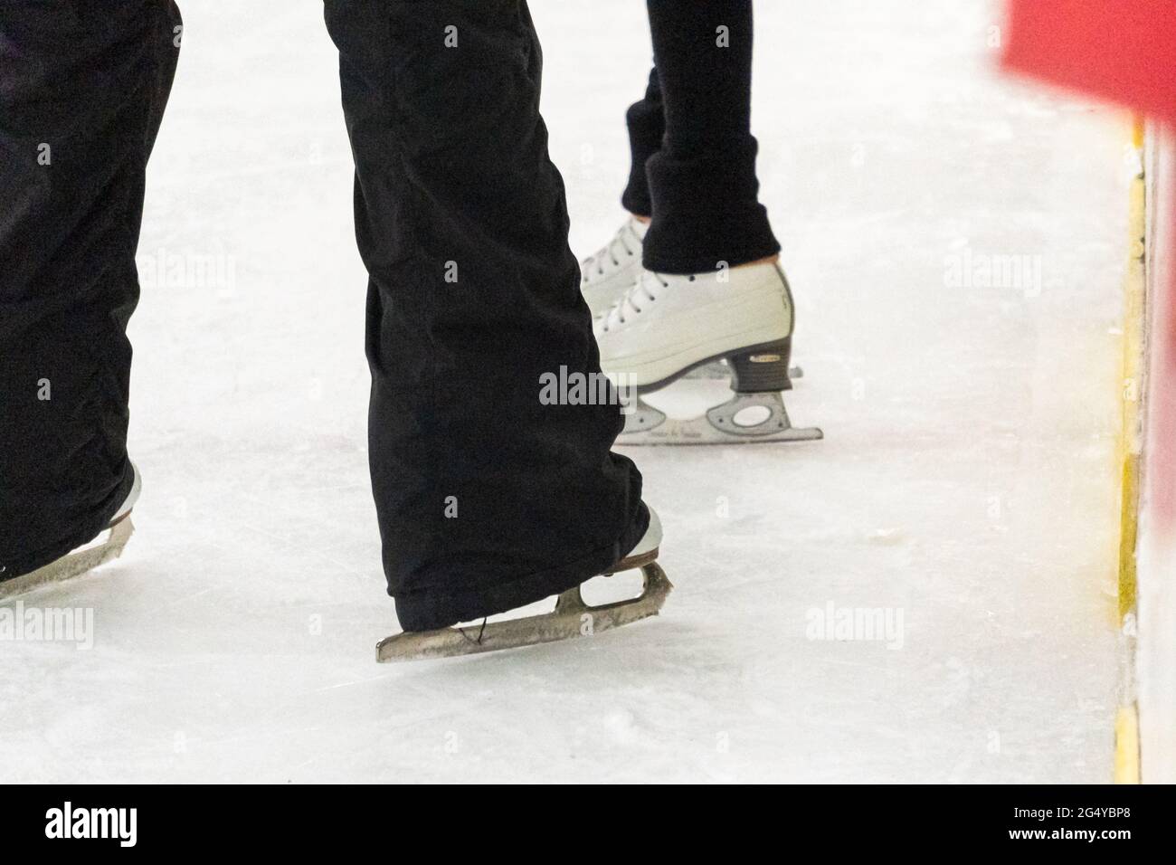 View of a figure skater and her coach feet at the figure skating ...