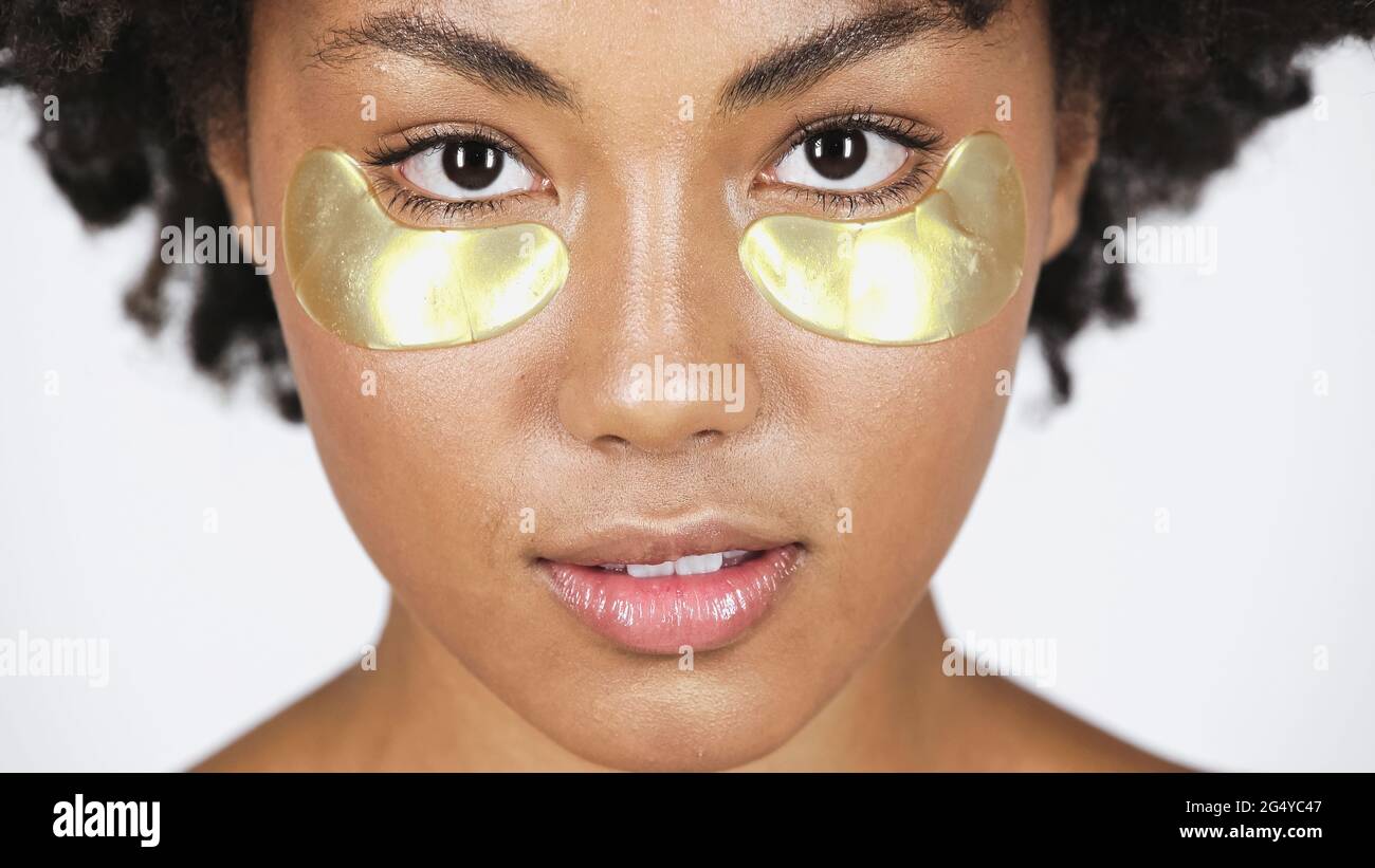 Close up view of african american woman with golden eye patches ...