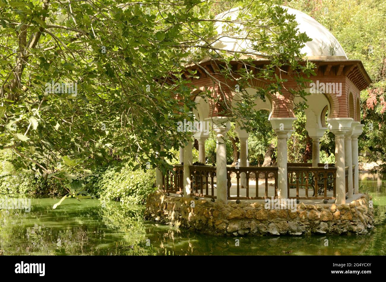 Garden gazebo on green pond in park of Seville, the capital of ...