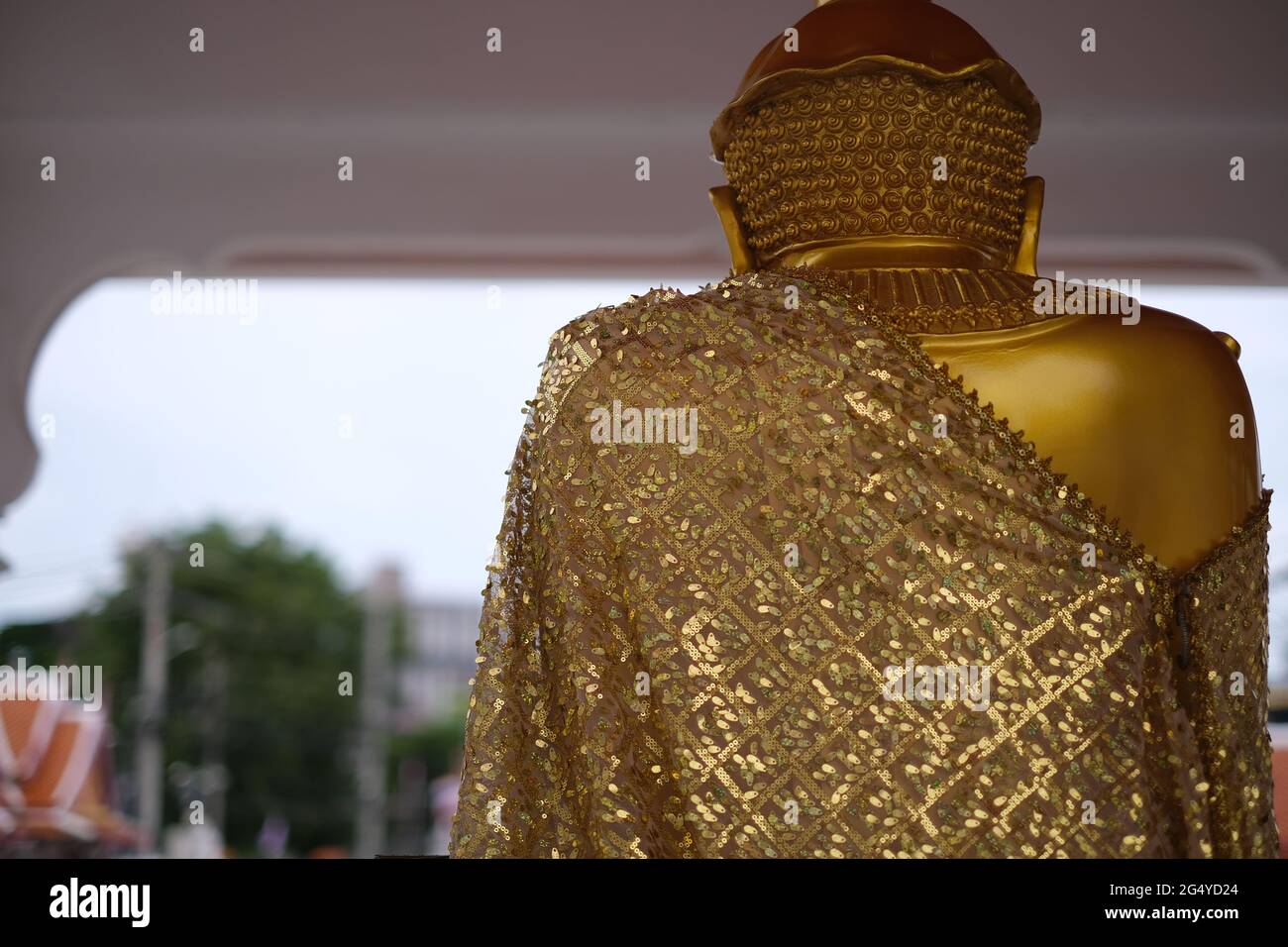Golden statue of Chinese God or Buddha, covered with golden mantle, in ...