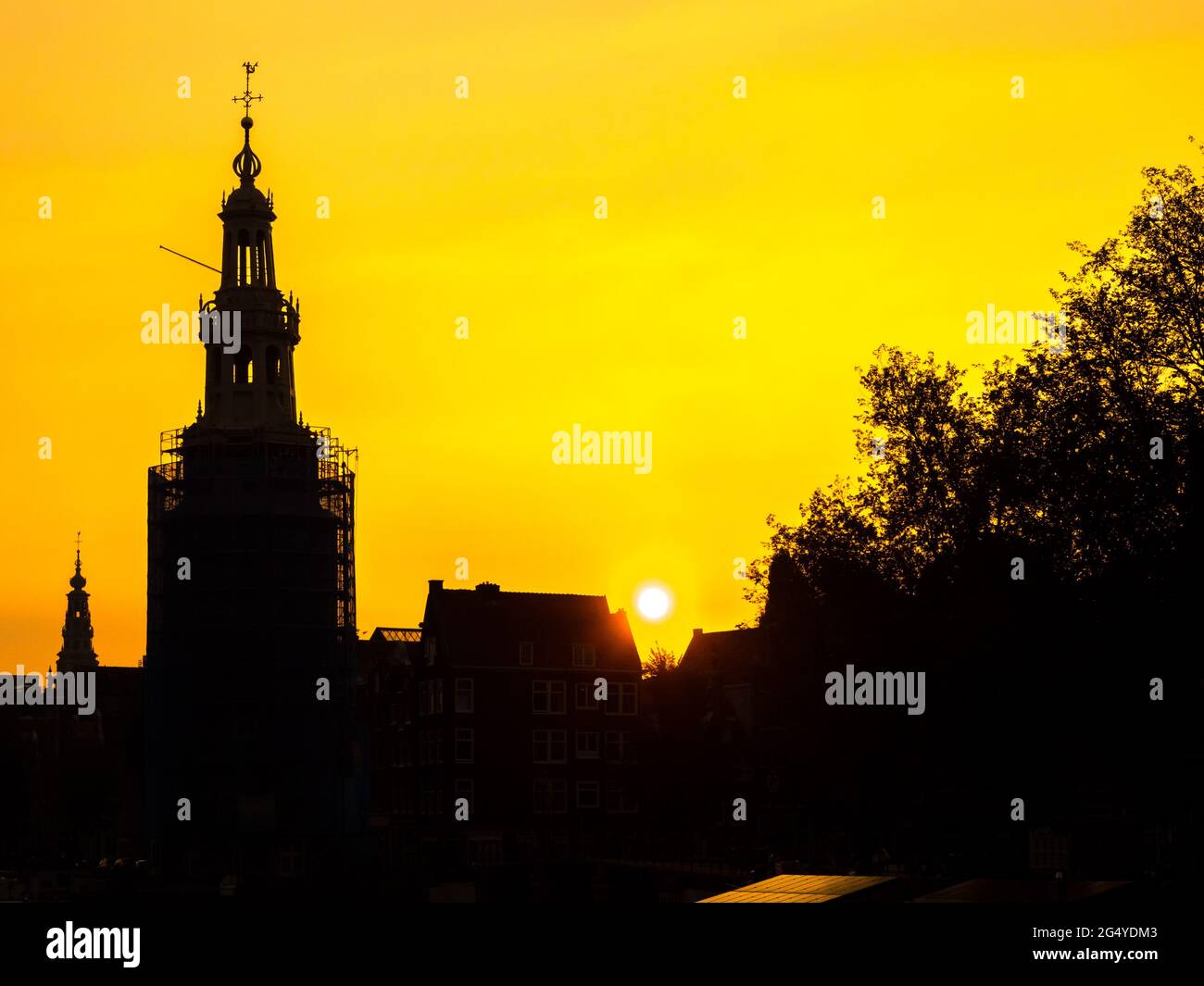 Silhouette technique of clock tower along canal in Amsterdam under ...