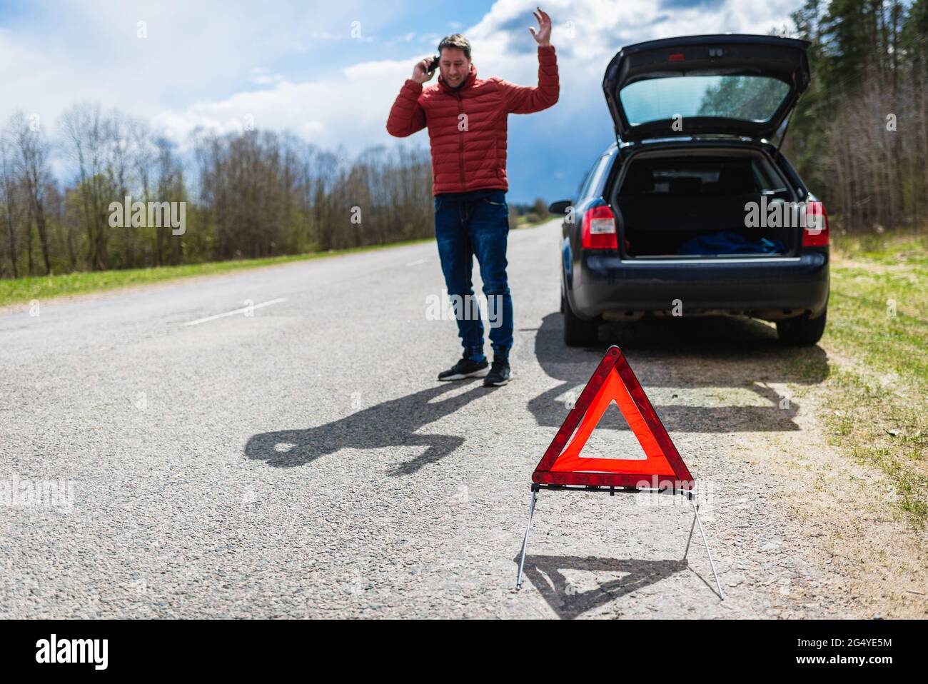 Angry Man calling repair service after car breakdown.youg man talking ...