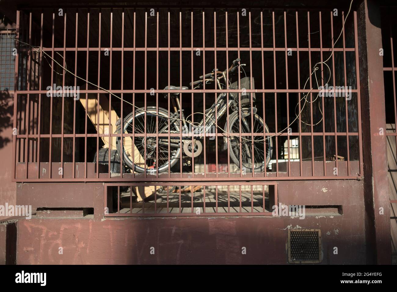 A bicycle leaning on the bars in a storehouse Stock Photo - Alamy