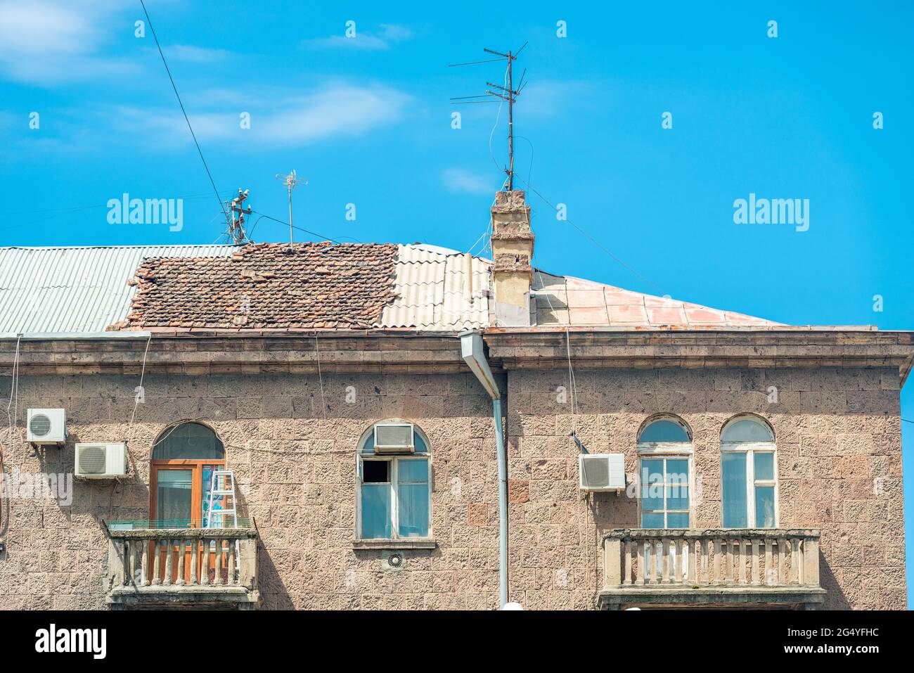 Red tile roof and TV antenna above the house Stock Photo - Alamy