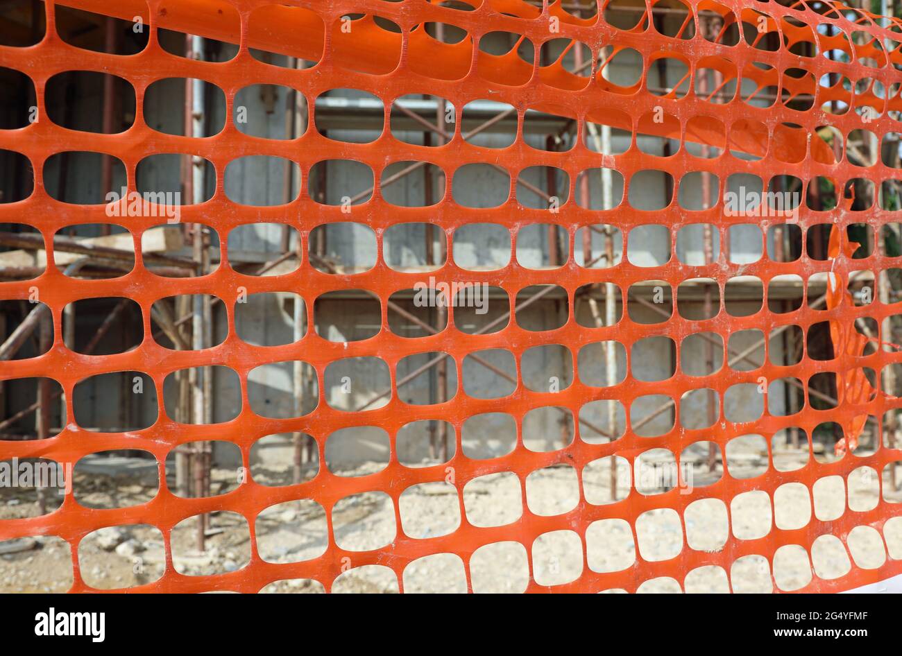 orange plastic net for the protection of the construction site during ...