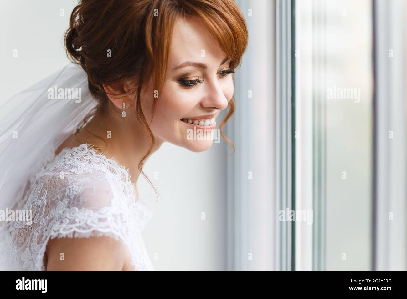 close-up portrait of the bride with a happy toothy smiling face ...