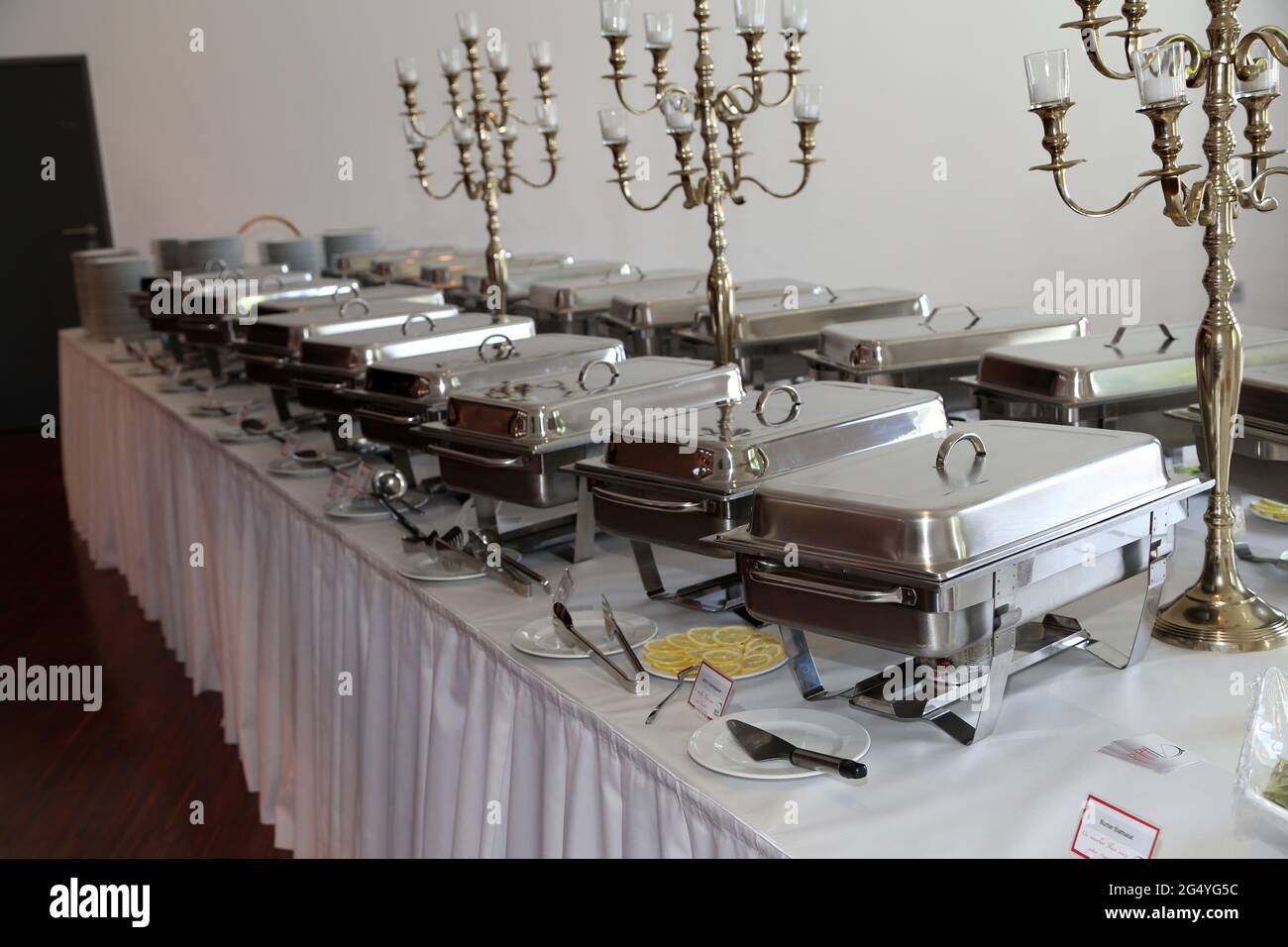 Row of covered dishes at a buffet Stock Photo - Alamy