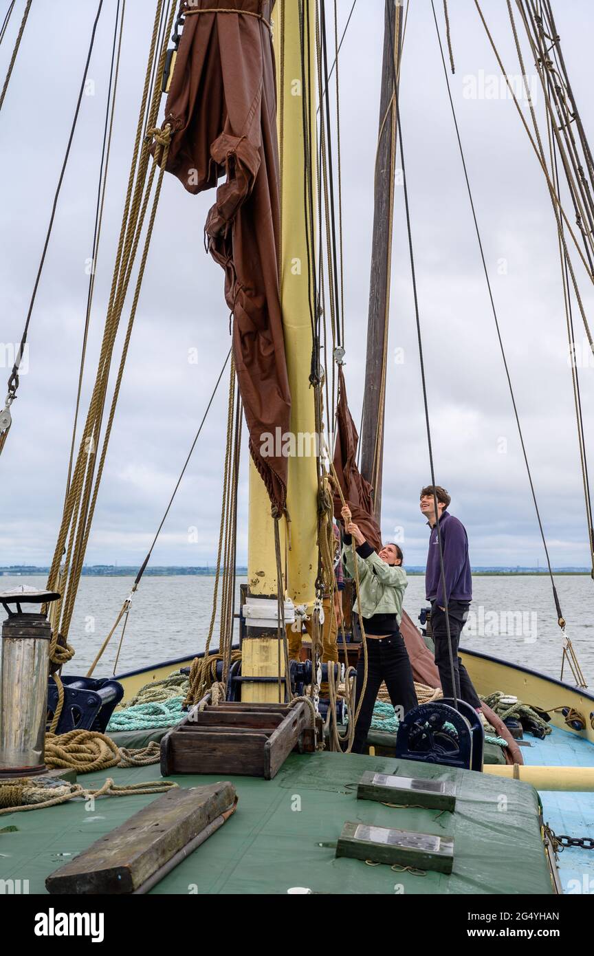 Learning the ropes: Two passengers on "Edith May" sailing barge helping ...