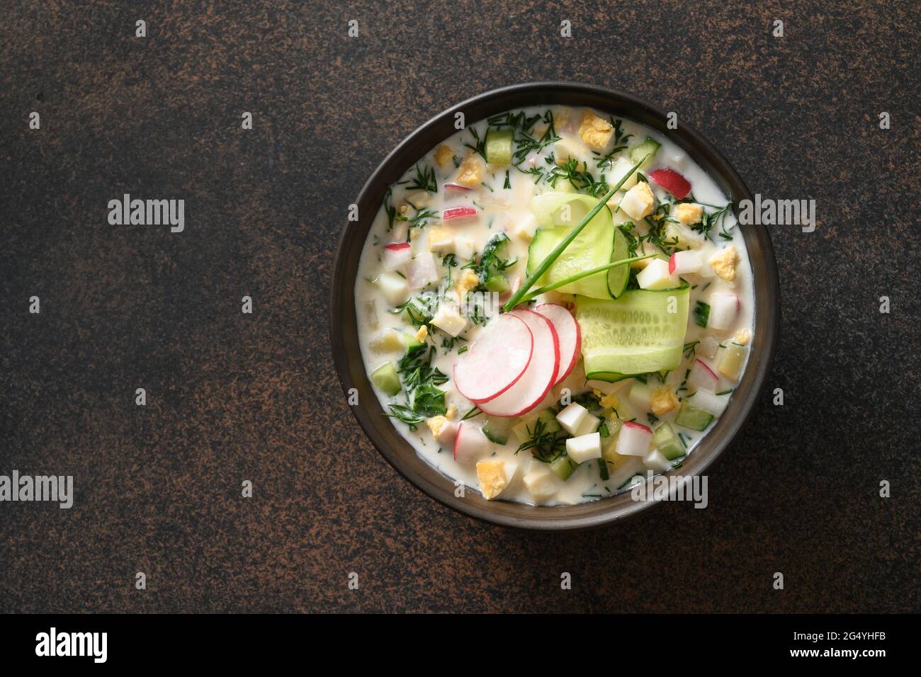 Traditional Russian cold vegetables okroshka soup with chopped cucumber ...