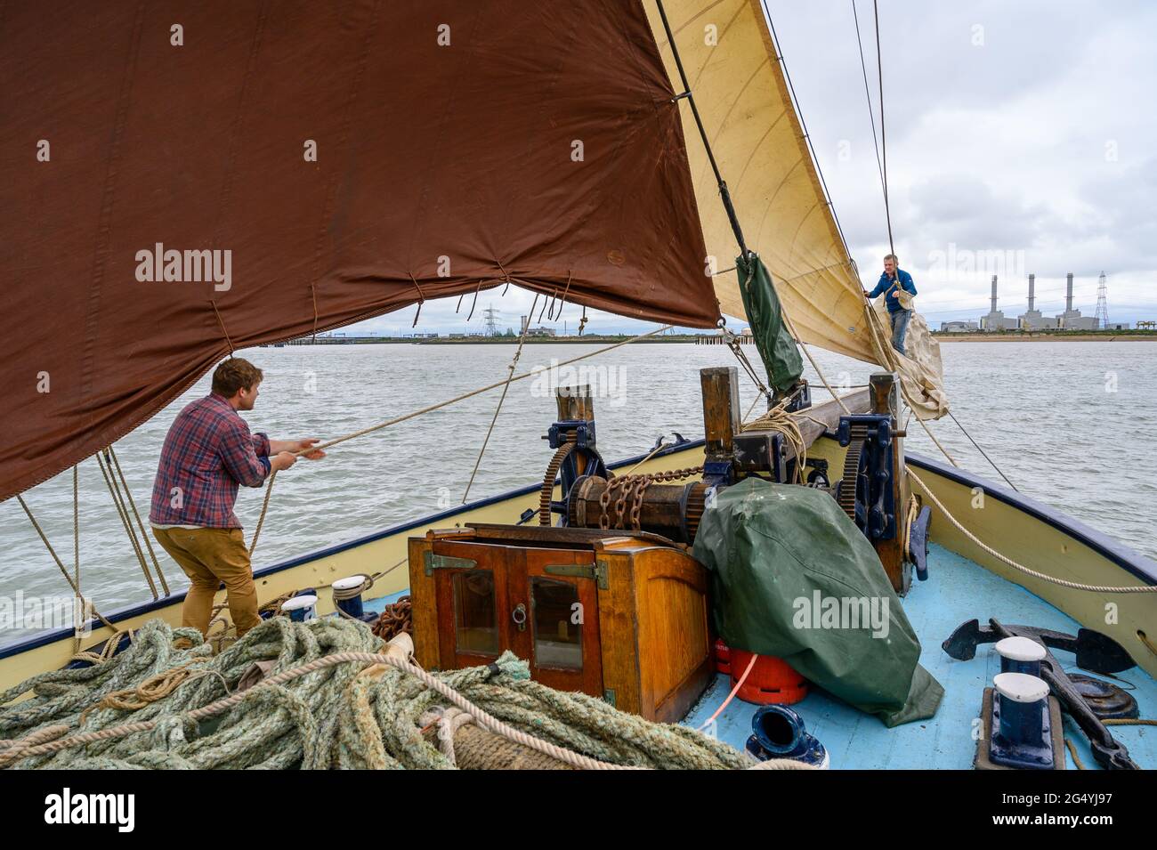 Mate Pat Fox and skipper Ed Gransden (left) stowing away the staysail ...