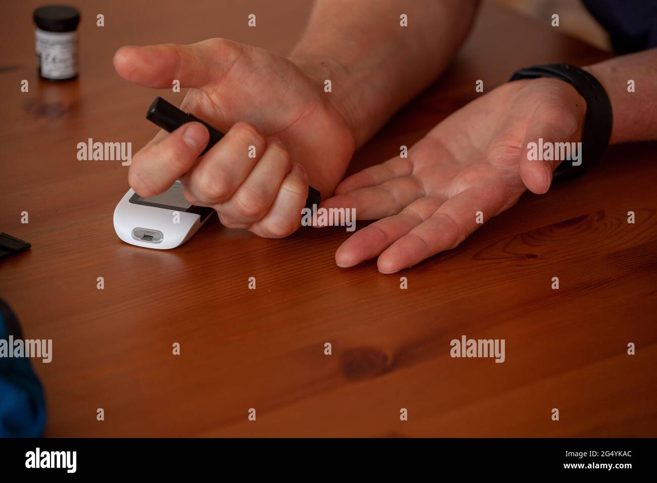 Close-up of a male hand testing blood for carbohydrates due to diabetes ...