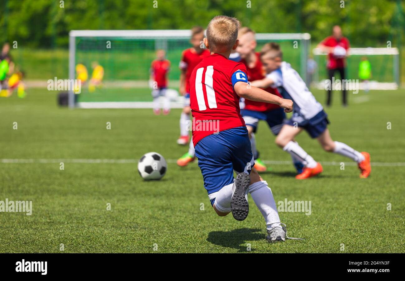 Group of Soccer Boys in Red Uniforms Playing School Tournament Game ...