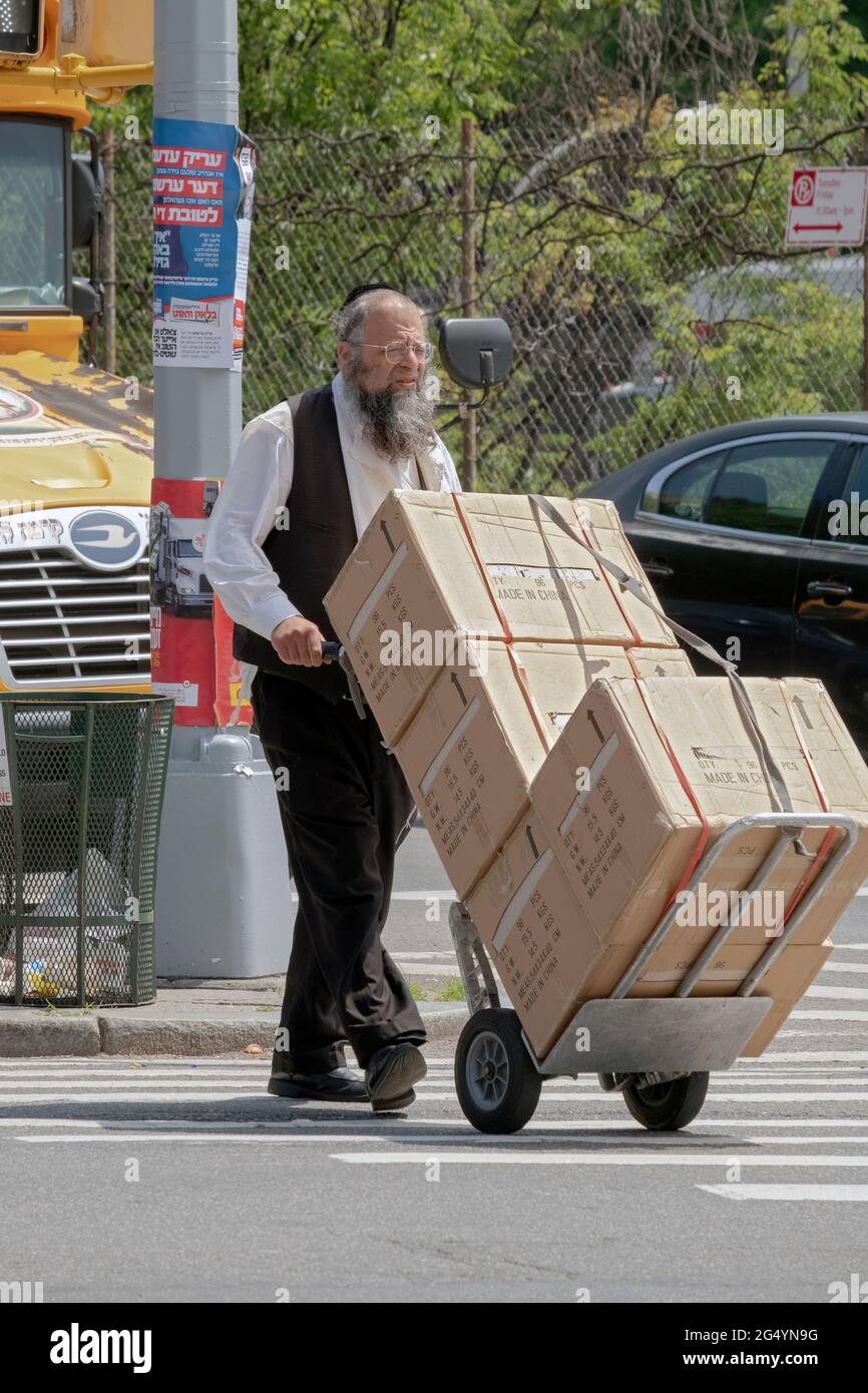 An orthodox Jewish man moves crates of items made in China. On ...