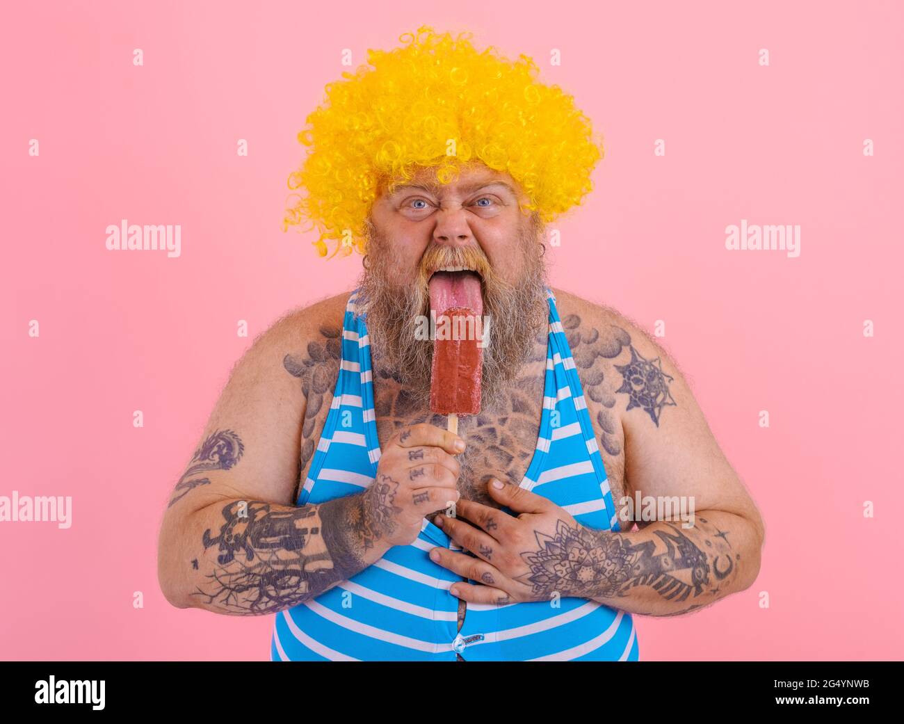 Fat hungry man with beard and wig eats a popsicle Stock Photo - Alamy