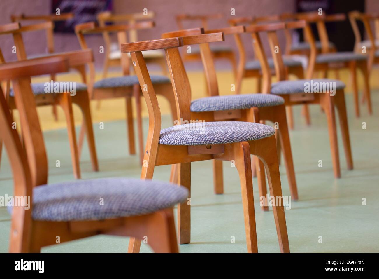 Group of chairs in an empty room spaced with a distance Stock Photo - Alamy