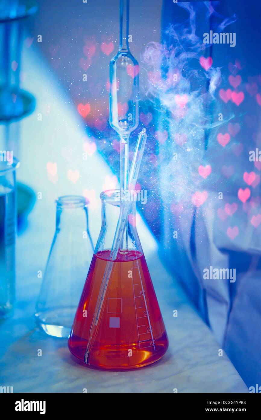 Glass laboratory flasks with chemical substance and magic glow. Making ...