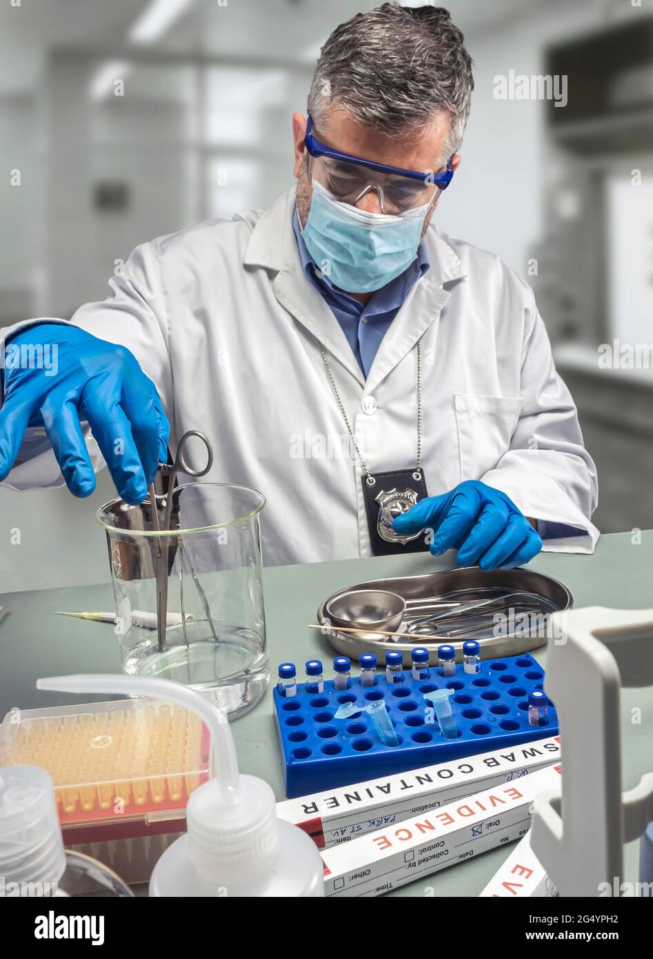 Police scientist is holding scissors in beaker in crime lab, concept ...