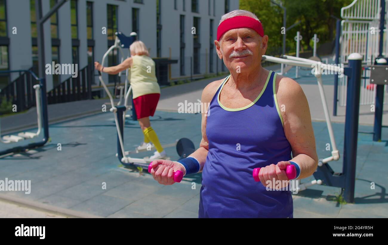 Senior man grandfather doing active training weightlifting exercising ...