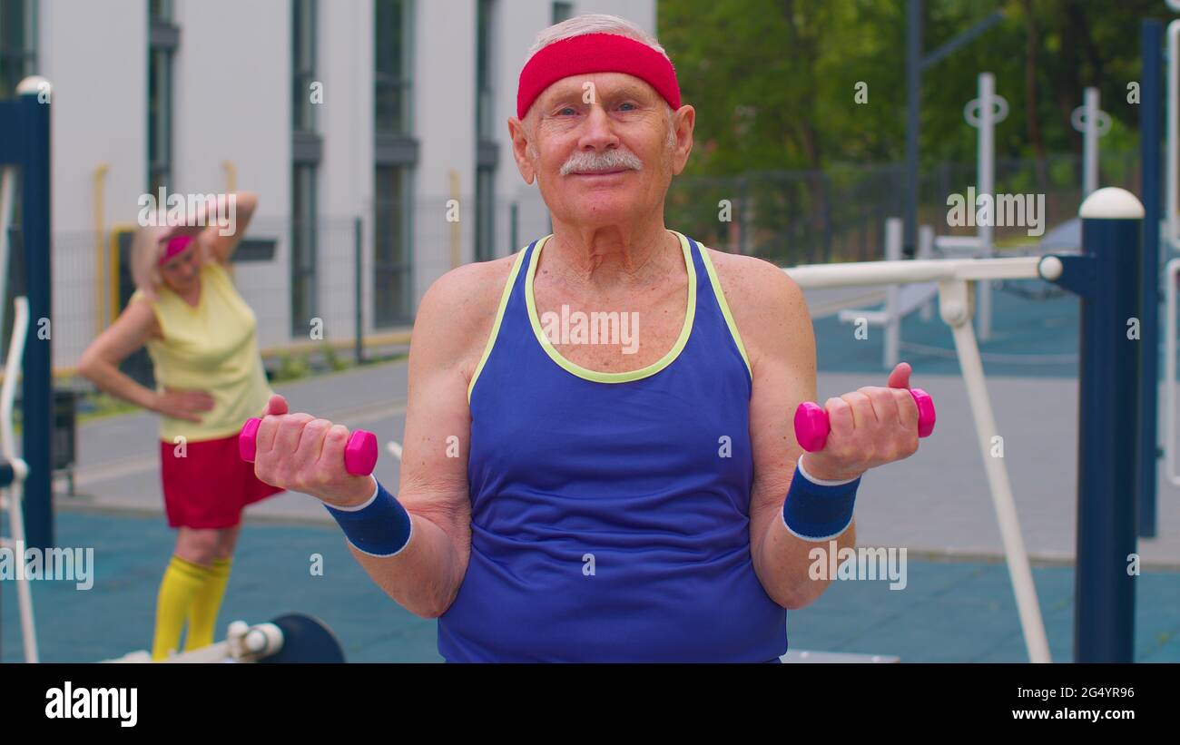 Senior man grandfather doing active training weightlifting exercising ...