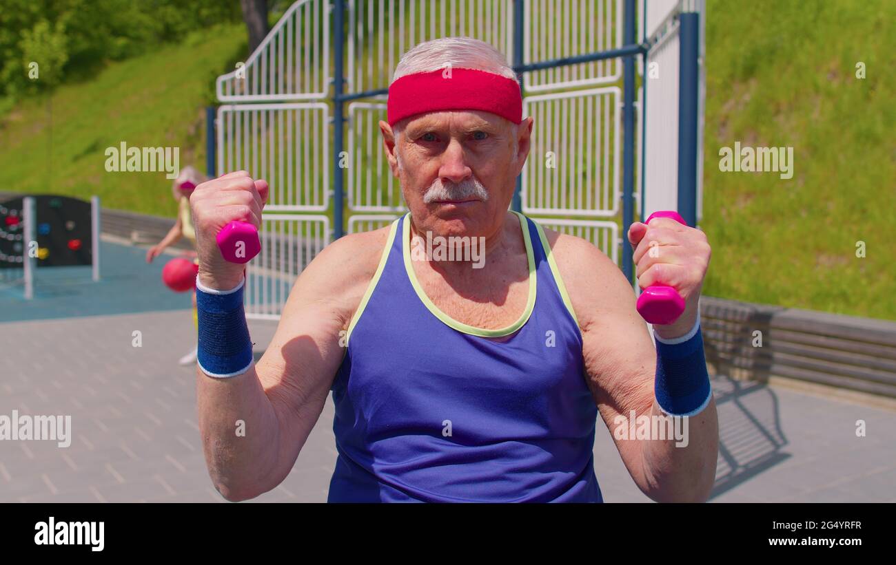 Senior man grandfather doing sport training boxing fitness aerobics ...