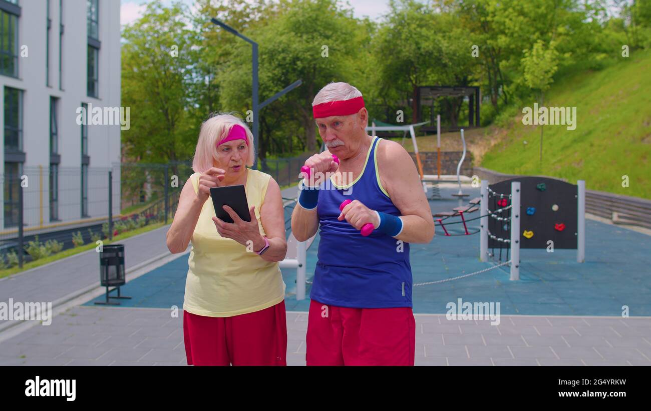 Senior old woman grandmother coach teaching grandfather with sport ...