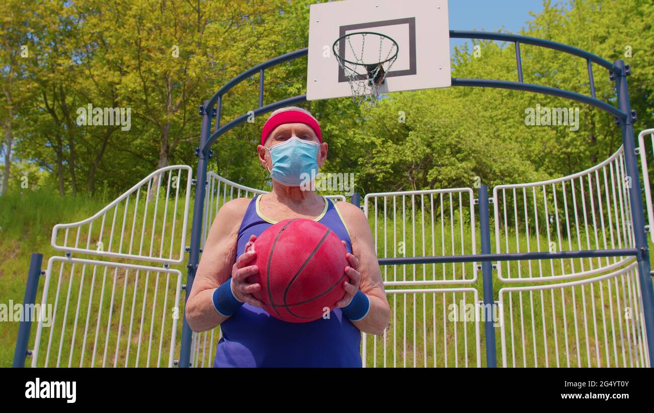 Senior old man grandfather athlete posing playing with ball outdoors on ...