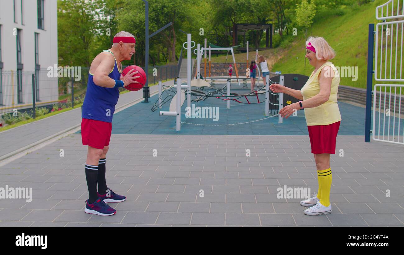 Senior basketball team couple man woman playing game with ball, pass to ...