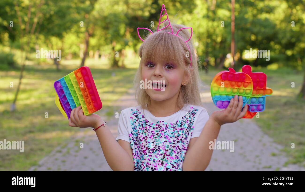 Stylish little child kid girl showing squishy silicone touch screen ...