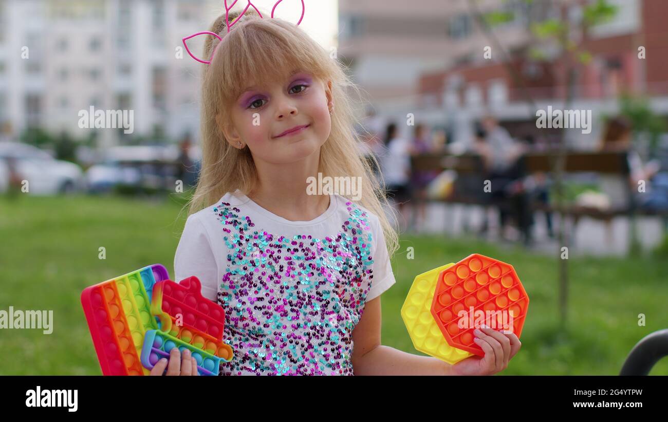 Stylish cute child kid girl showing squishy silicone touch screen ...